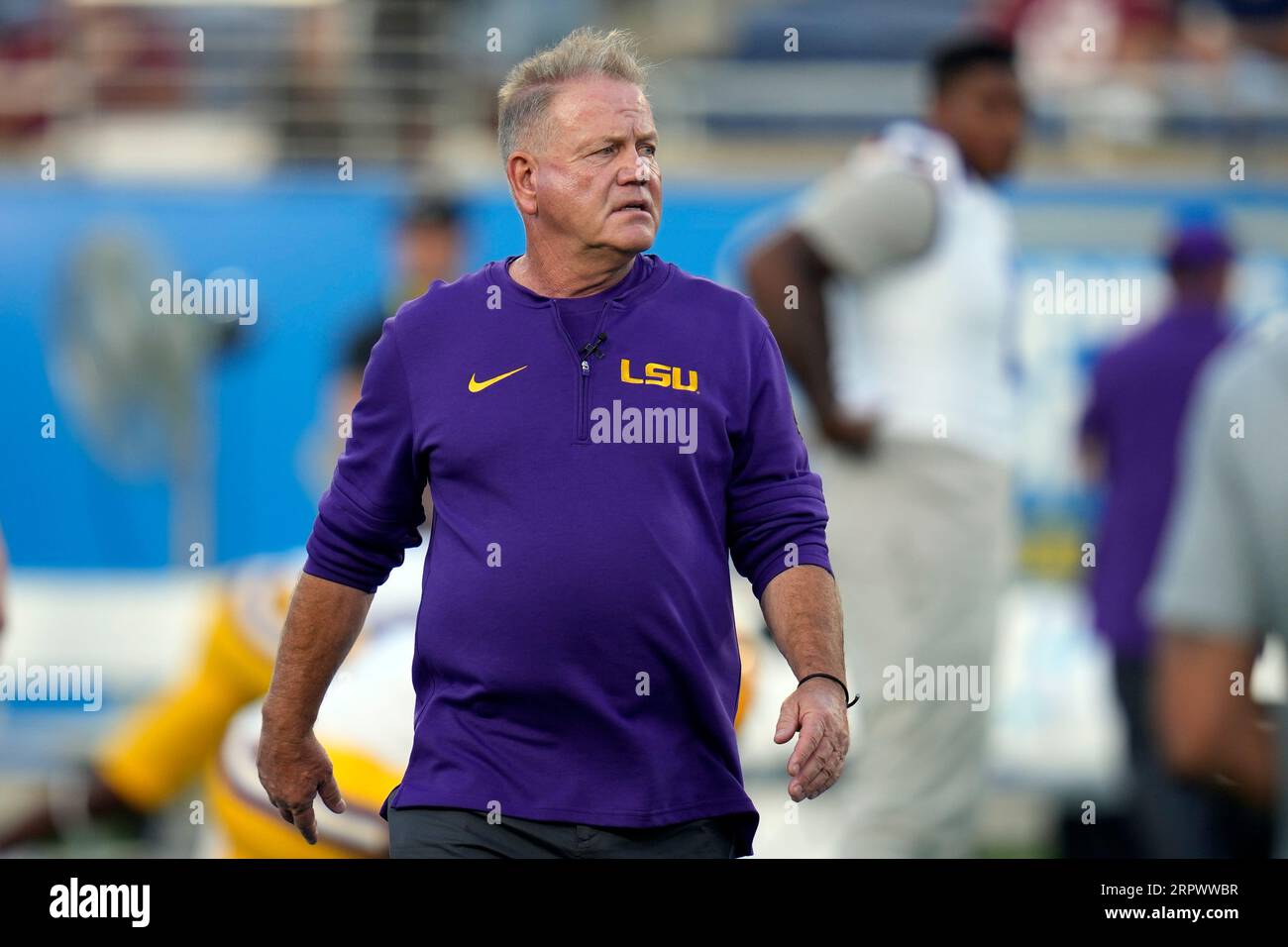 LSU head coach Brian Kelly watches players warm up before the first ...