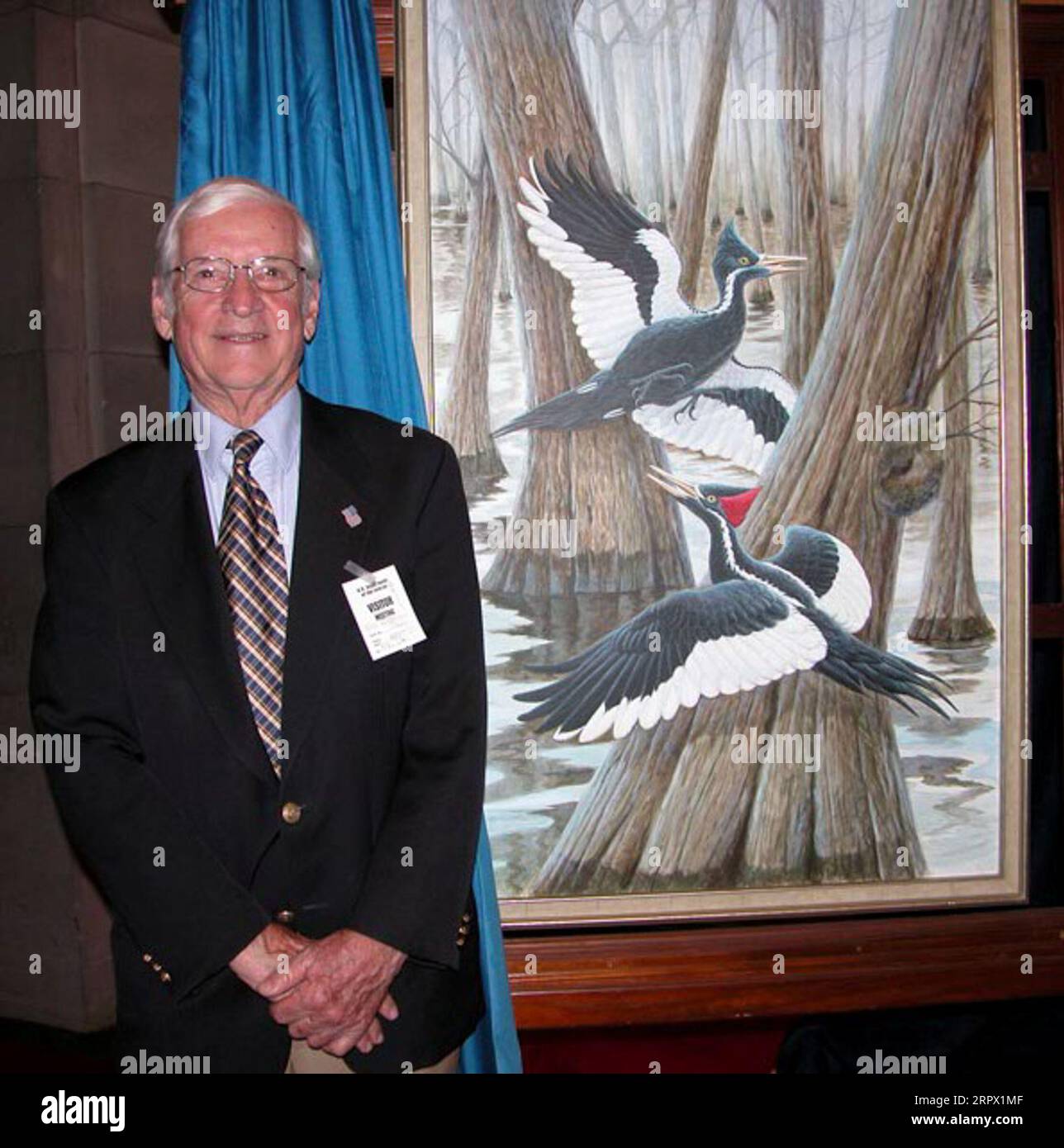 Artist John Ruthven with his painting of the ivory-billed woodpecker at ...