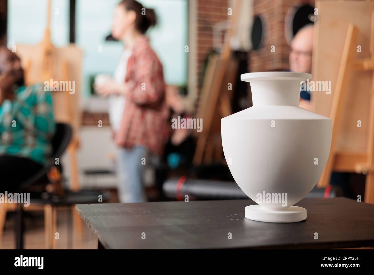 Still life drawing lessons. Ceramic vase standing on table in art room ...