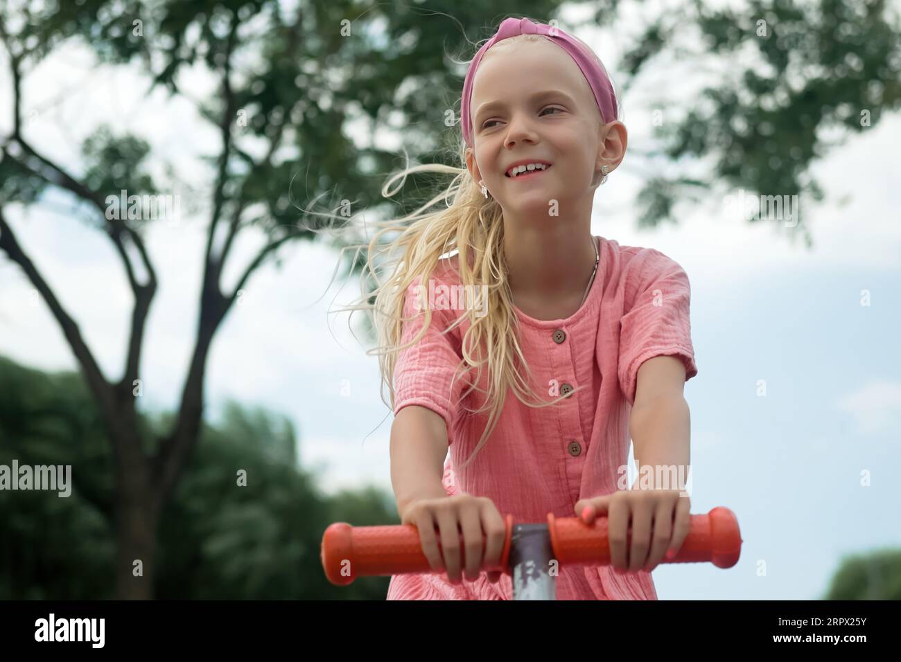 A joyous child on a seesaw in an urban park's playground, sharing ...