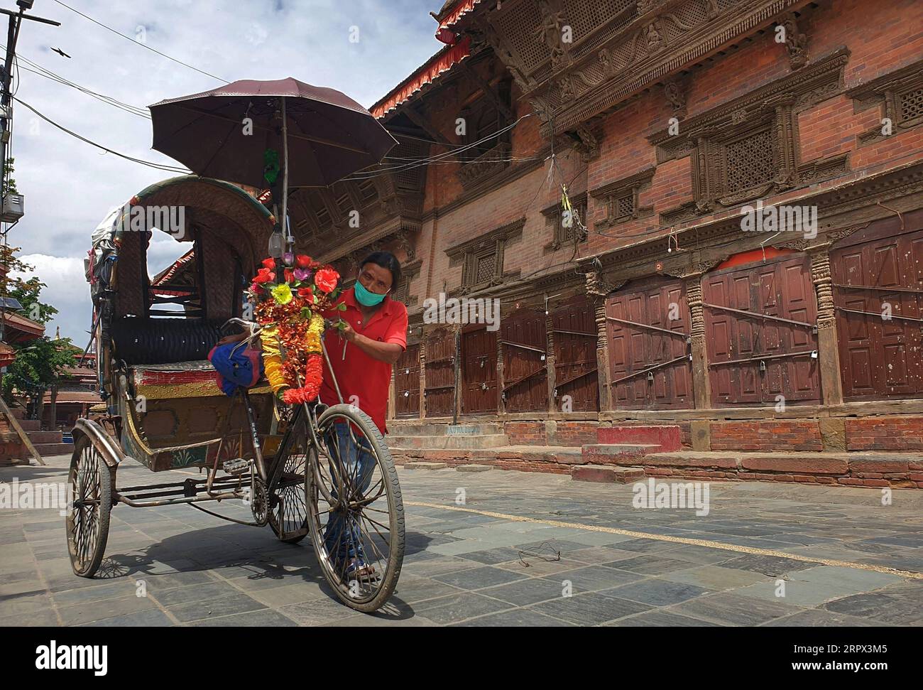 200505 -- KATHMANDU, May 5, 2020 -- A rickshaw rider is seen at ...