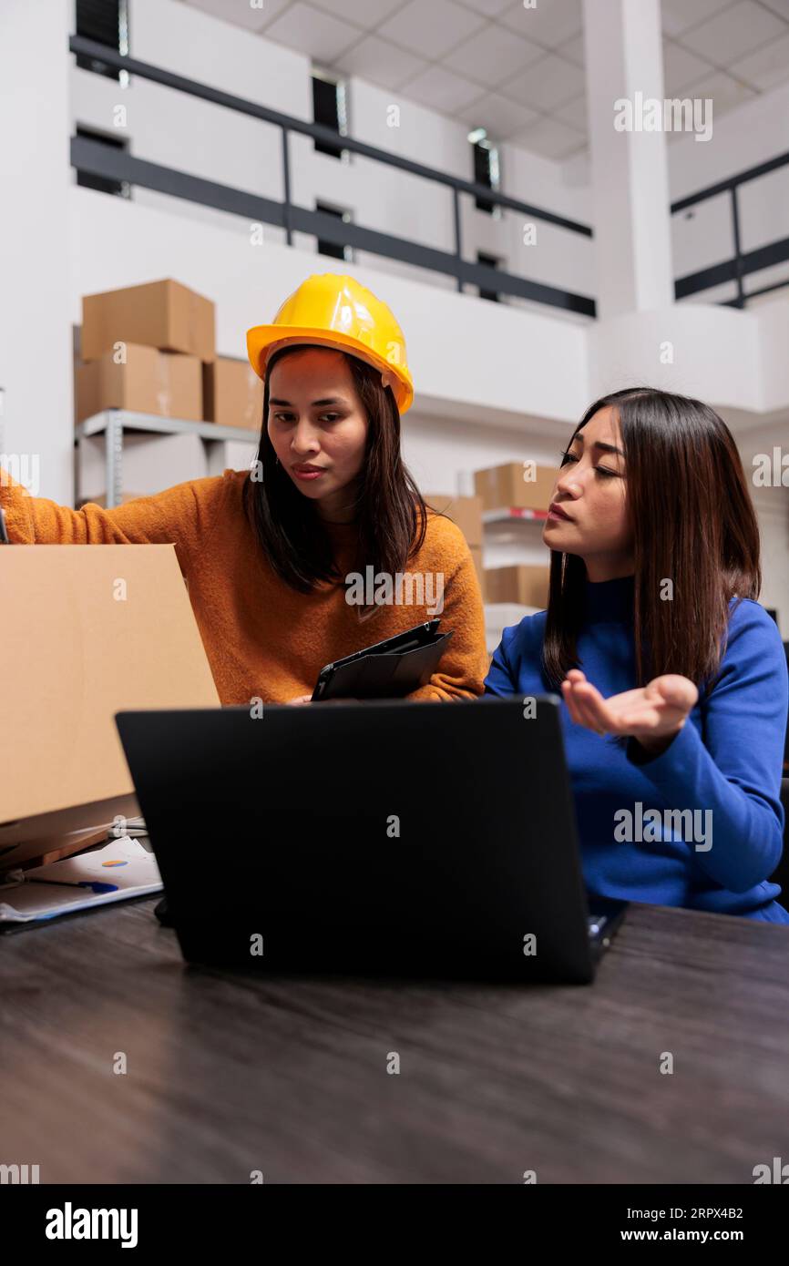 Asian women logistics managers planning inventory management on laptop ...