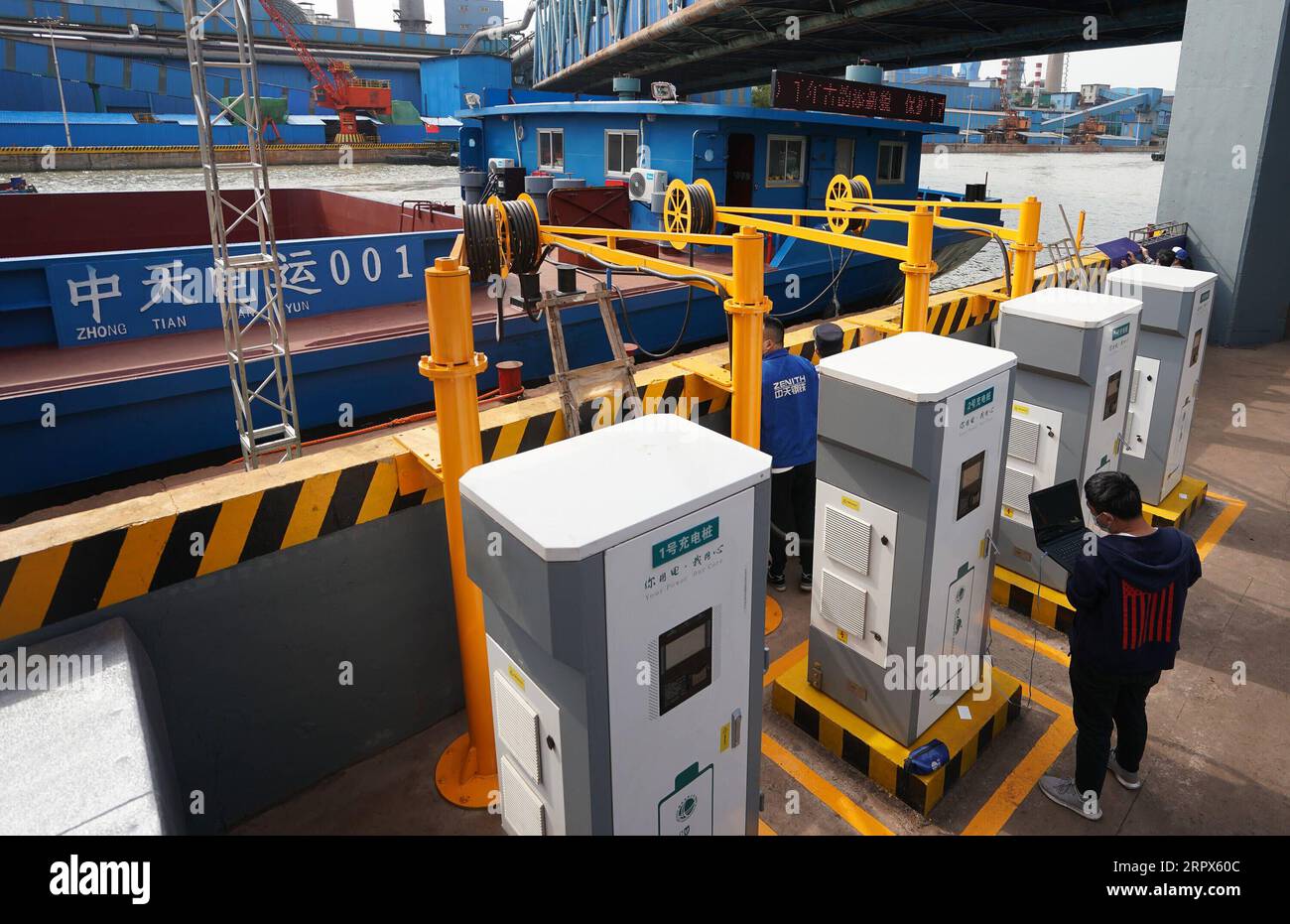 200509 -- NANJING, May 9, 2020 -- A worker prepares charging piles for ...