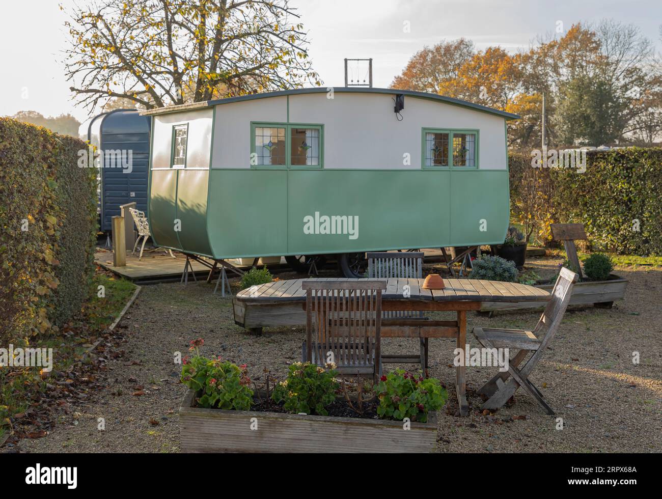 Classic old green and cream caravan with outdoor dining table Stock ...
