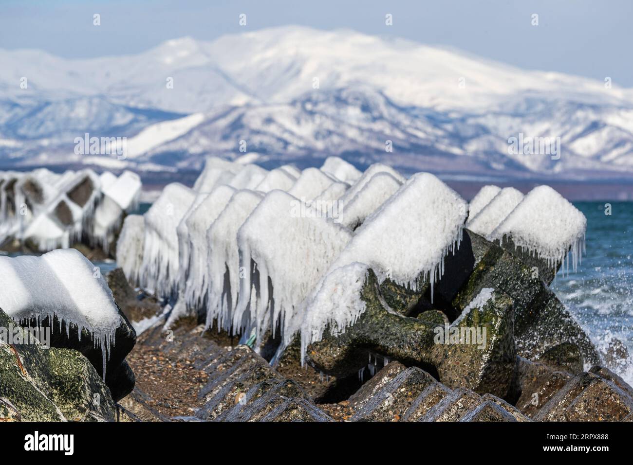 Ice covered concrete blocks as waves breakers on the Japanese beach in ...