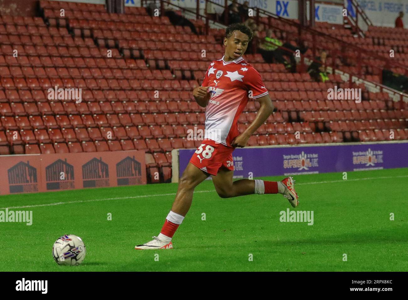 Theo Chapman #38 of Barnsley breaks with the ball during the EFL Trophy ...
