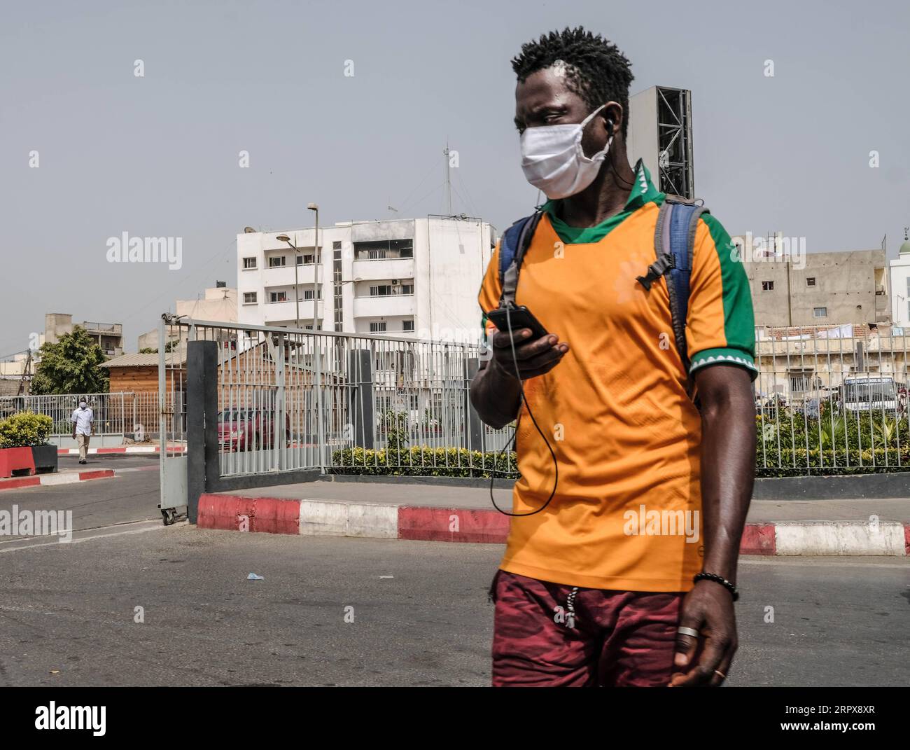 200514 -- DAKAR, May 14, 2020 Xinhua -- A man wearing a face mask walks ...