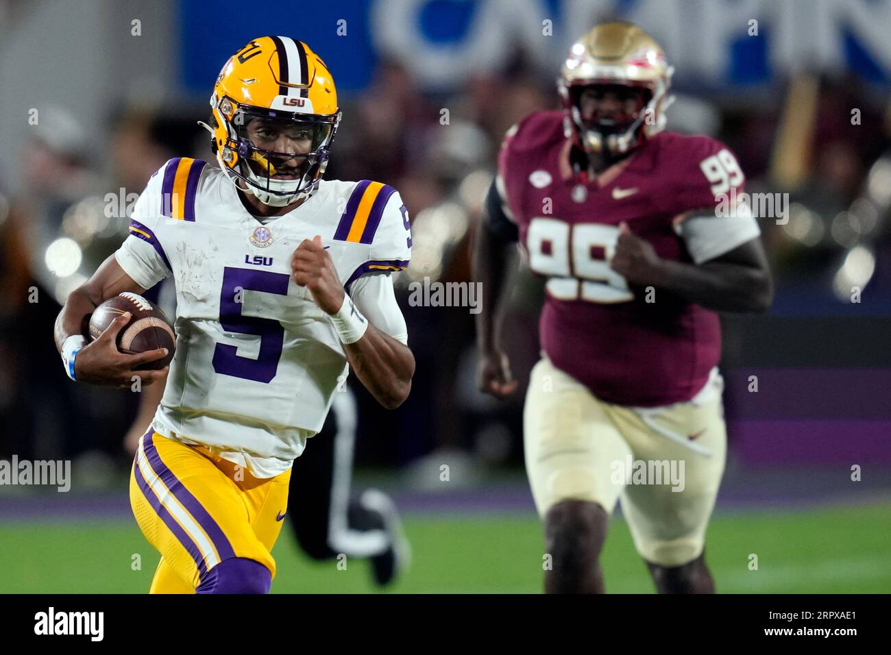 LSU quarterback Jayden Daniels (5) runs past Florida State defensive ...
