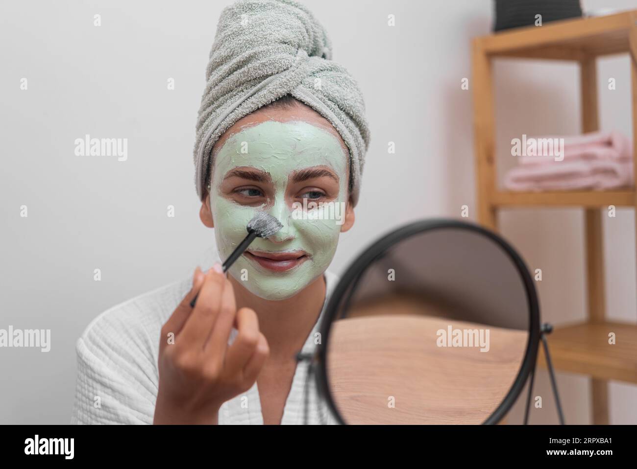 Skin Rejuvenation: woman pampers face with moisturizing mask ...