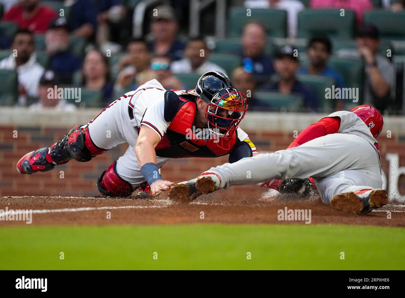 St. Louis Cardinals' Nolan Arenado, right, beats the tag from Atlanta Braves catcher Sean Murphy ...