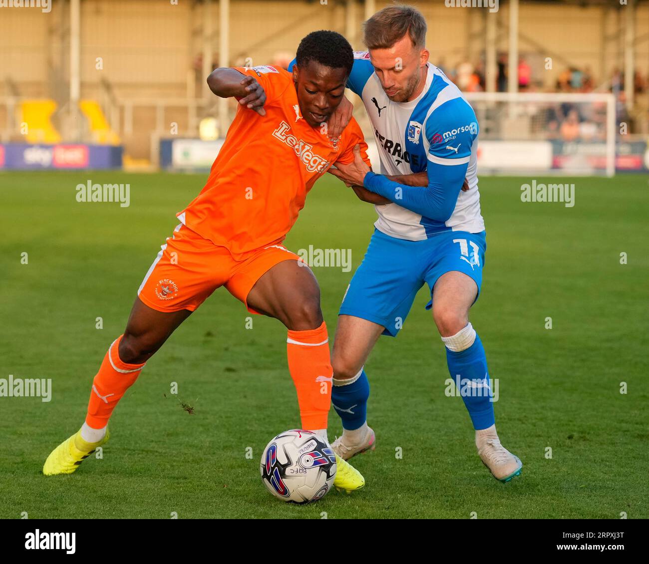 Elliot Newby #11 of Barrow holds on to Karamoko Dembele #11 of ...
