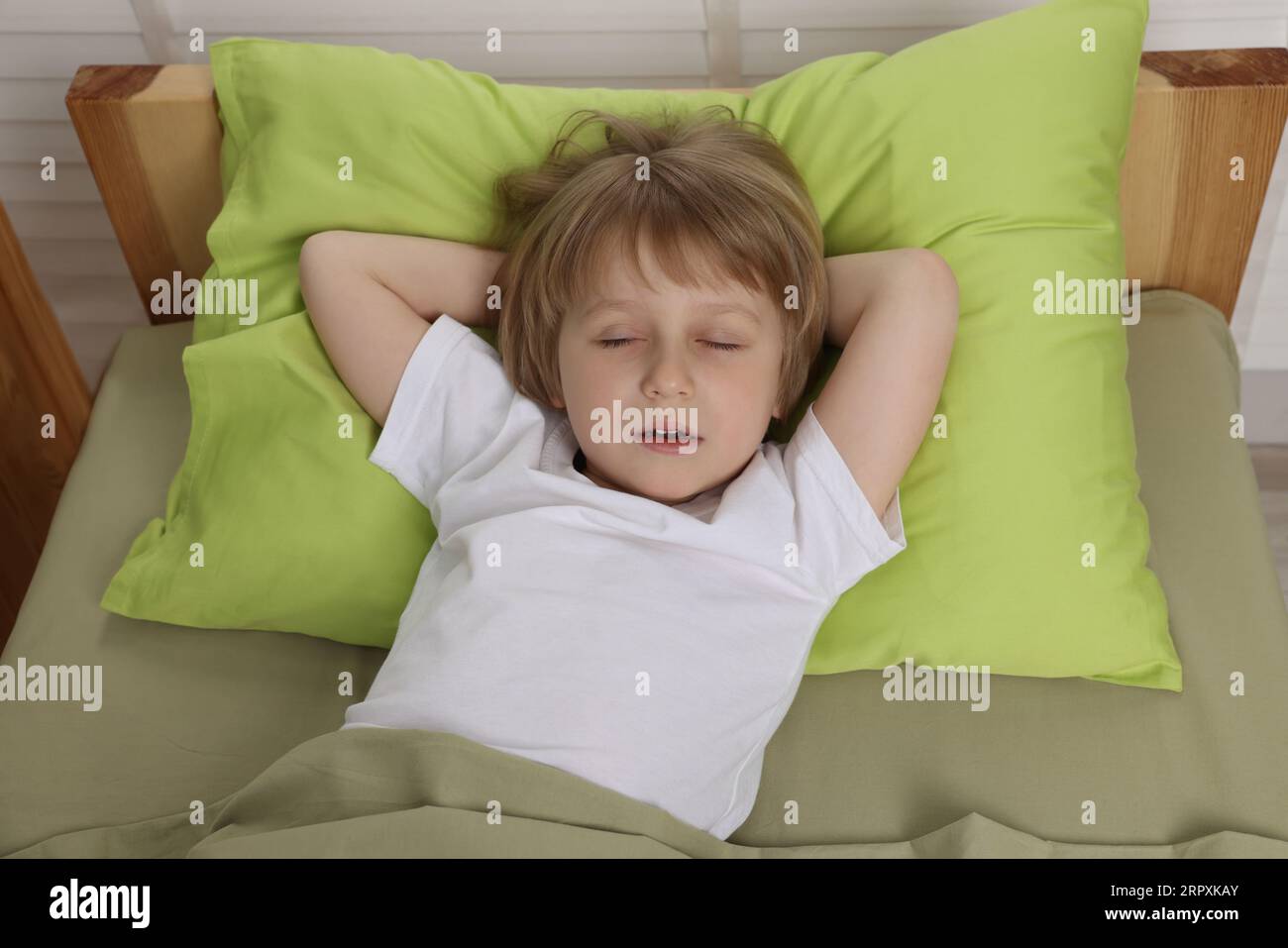 Little boy snoring while sleeping in bed at home, above view Stock ...