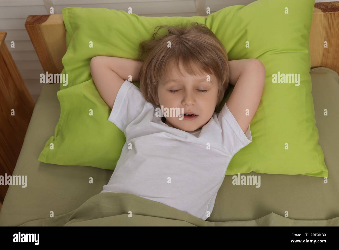 Little boy snoring while sleeping in bed at home, above view Stock ...