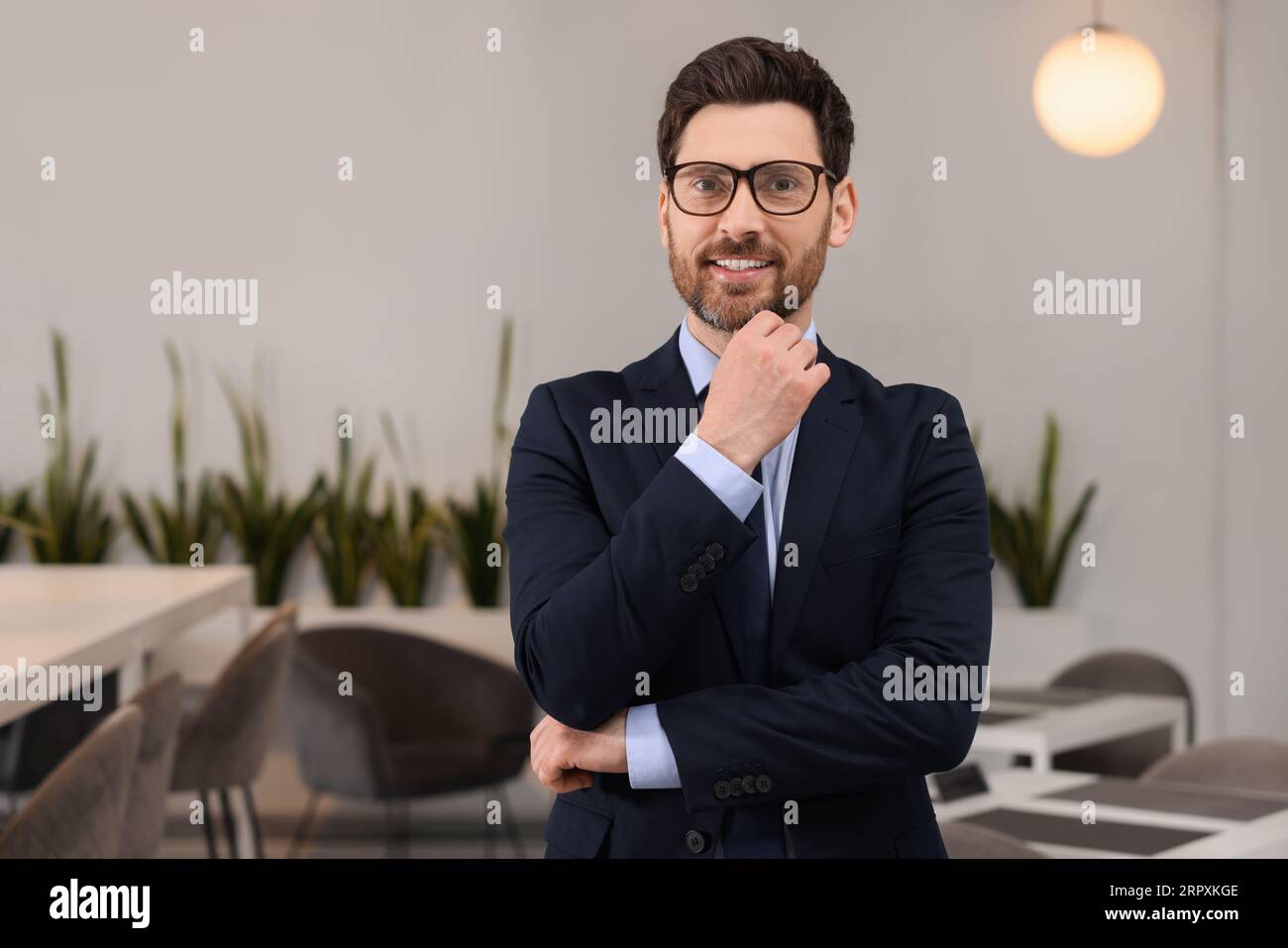 Happy real estate agent indoors. Space for text Stock Photo - Alamy