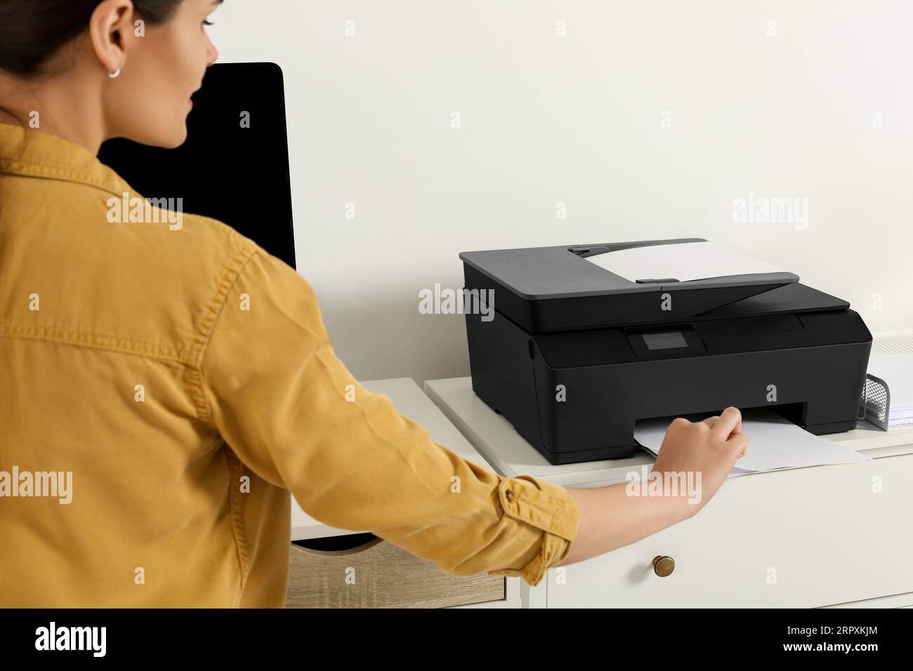 Person using black printer at home hi-res stock photography and images ...