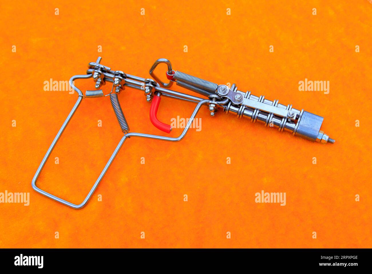 toy guns made by iron wire in orange background Stock Photo - Alamy