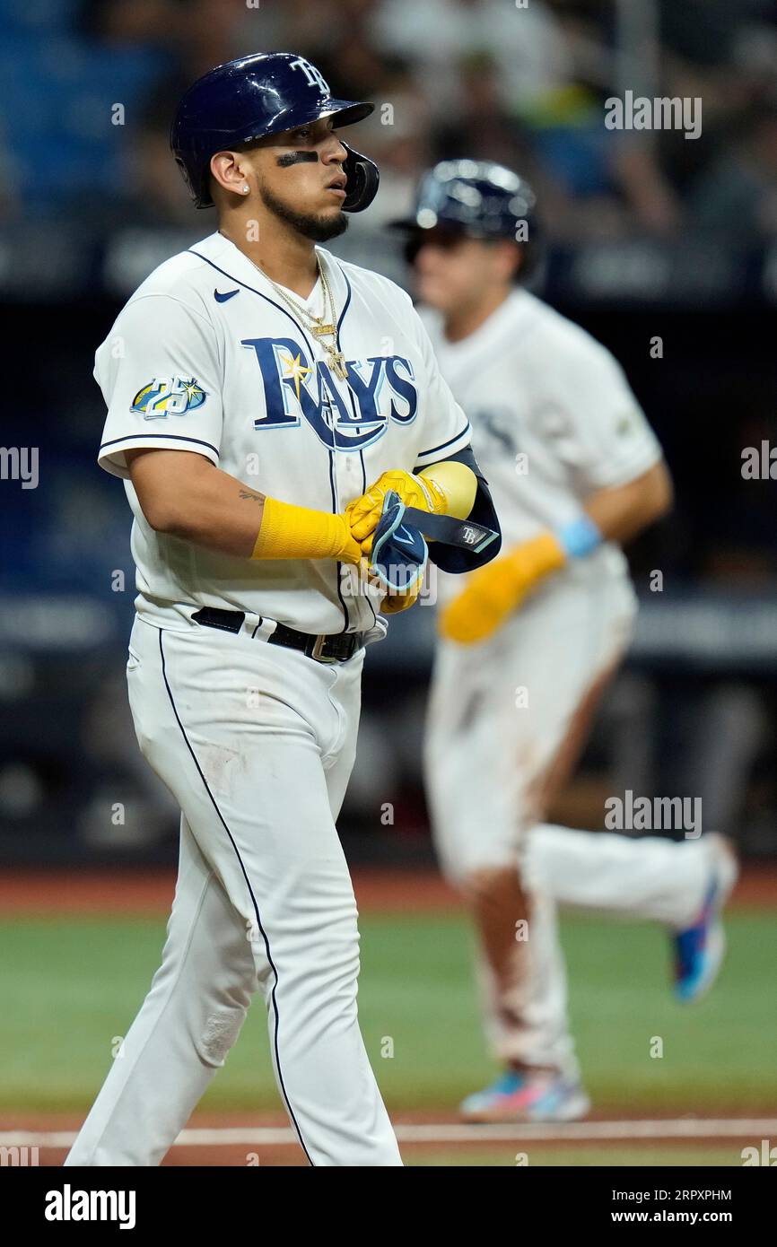 Tampa Bay Rays' Isaac Paredes, left, heads for first base as Jonathan ...