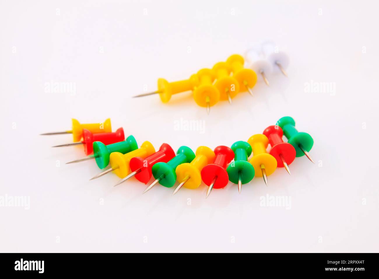 color drawing pin on white background Stock Photo - Alamy