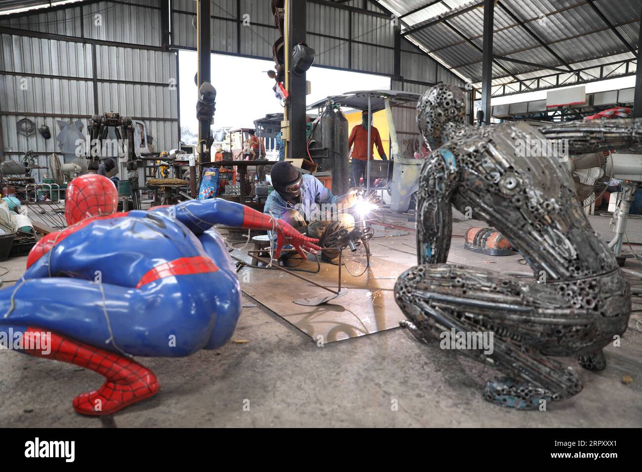 200605 -- ANG THONG, June 5, 2020 -- An artist welds parts of robots at ...