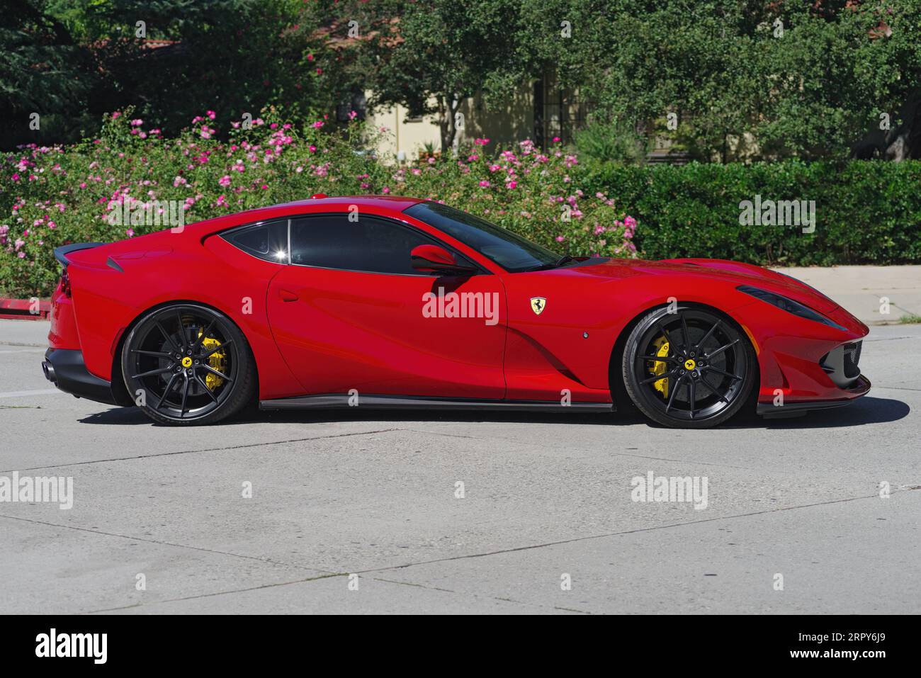Red Ferrari 812 Superfast shown driving in a residential area Stock ...