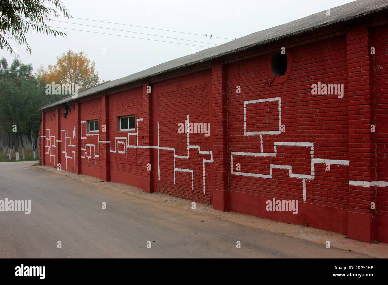 Graphic symbol in dark red house on the wall Stock Photo - Alamy