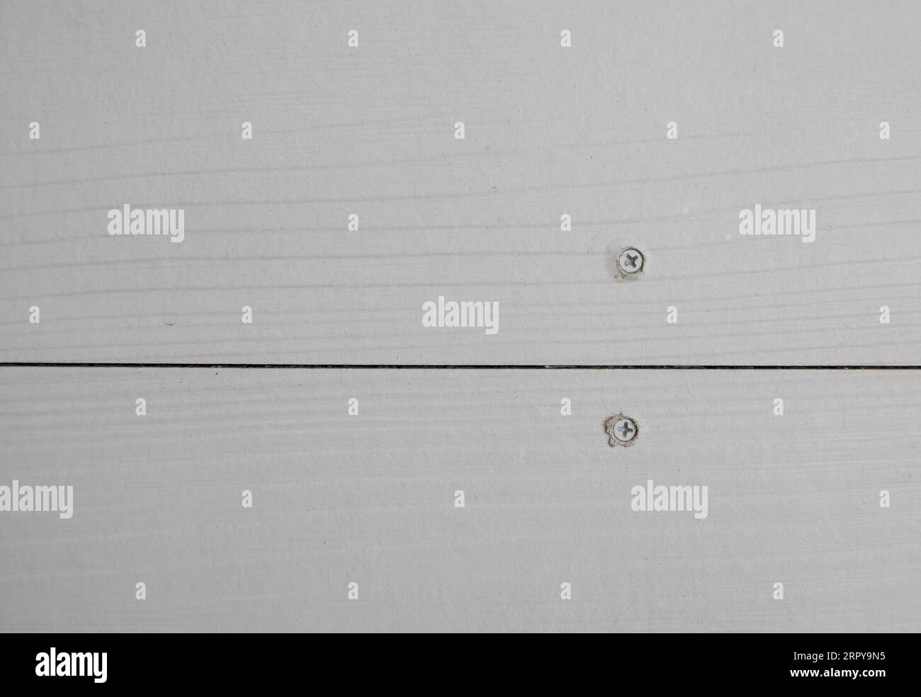 Screw fixing on white synthetic wood flooring Stock Photo - Alamy