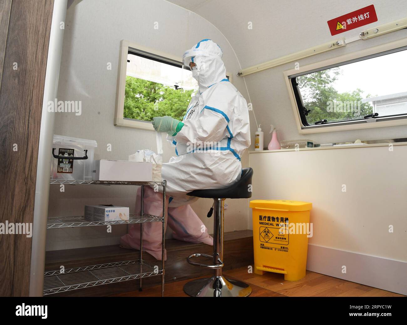 200624 -- BEIJING, June 24, 2020 -- A medical worker works in a movable ...