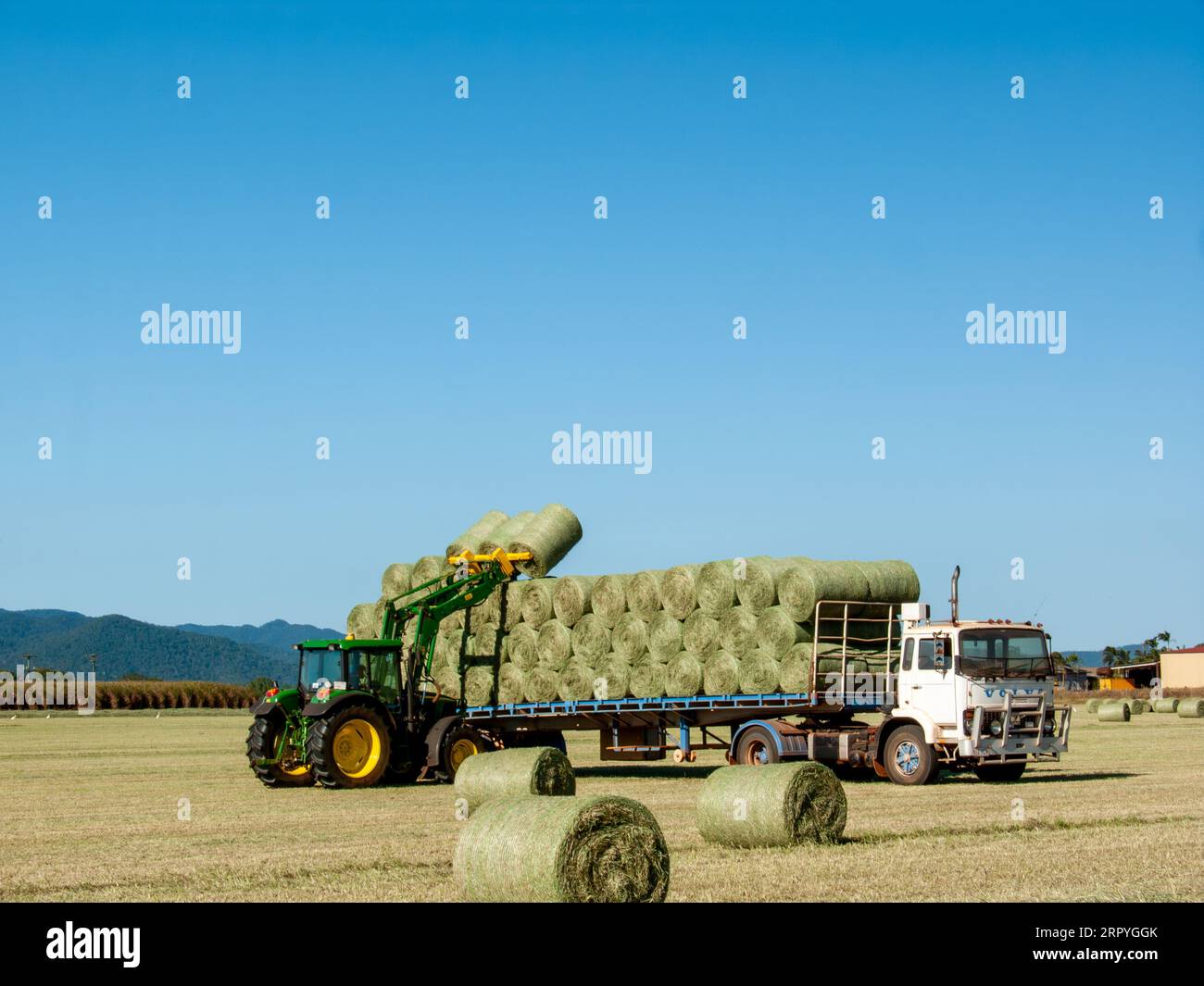 Loading Circular Hay Bales onto Truck, Kiri, Australia Stock Photo - Alamy