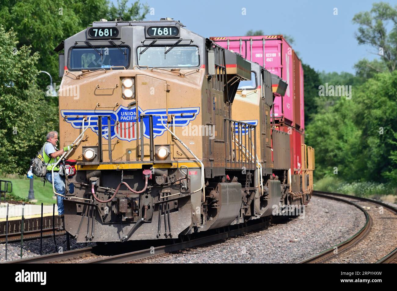 Winfield, Illinois, USA. An engineer climbs the steps of the lead locomotive of a paused Union ...
