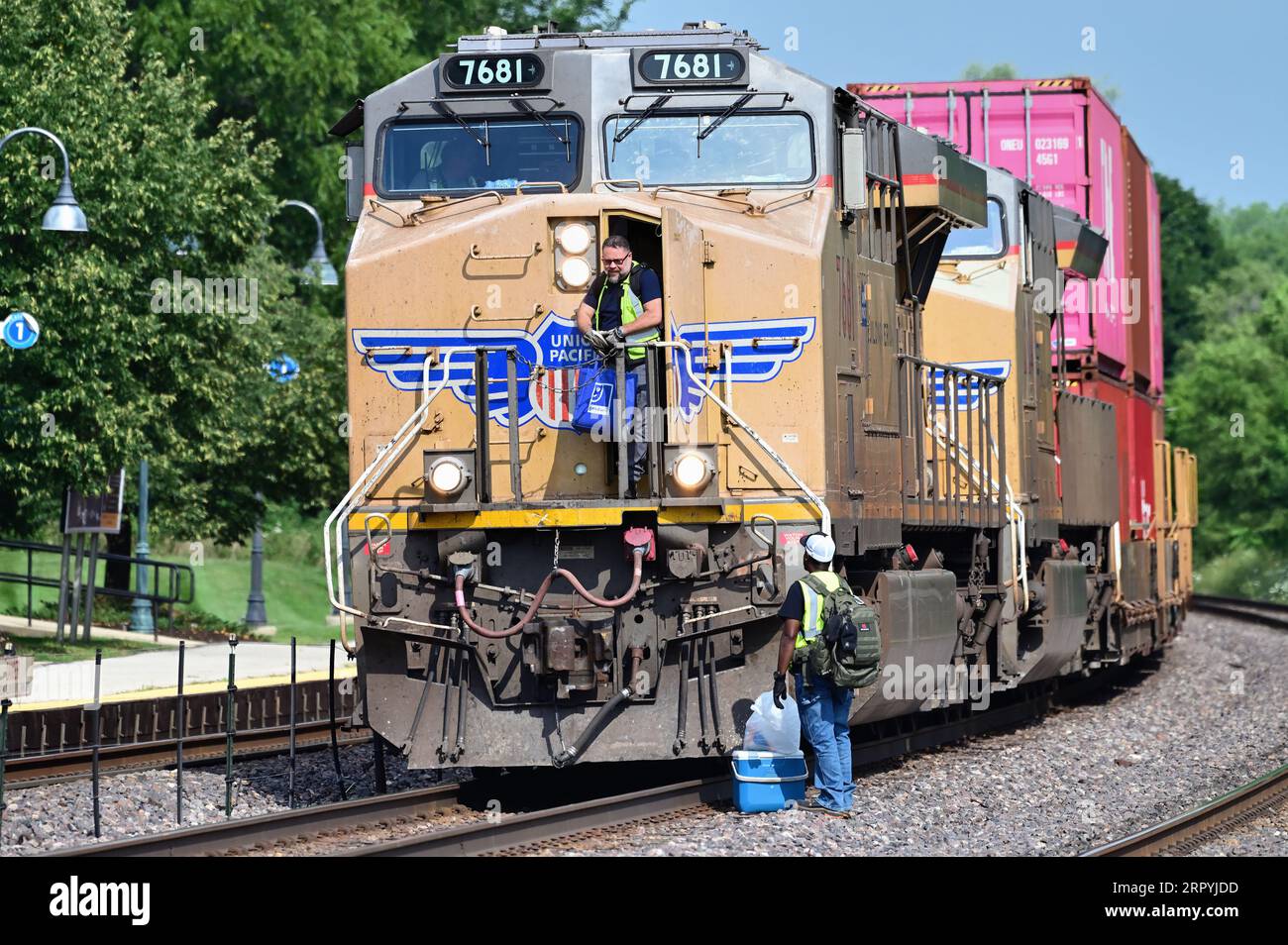 Winfield, Illinois, USA. An engineer exits an access door of the lead locomotive while another ...