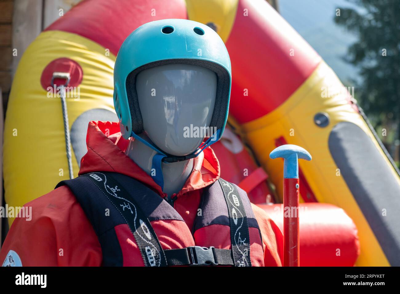 A mannequin in a red life jacket next to an inflatable boat Stock Photo ...