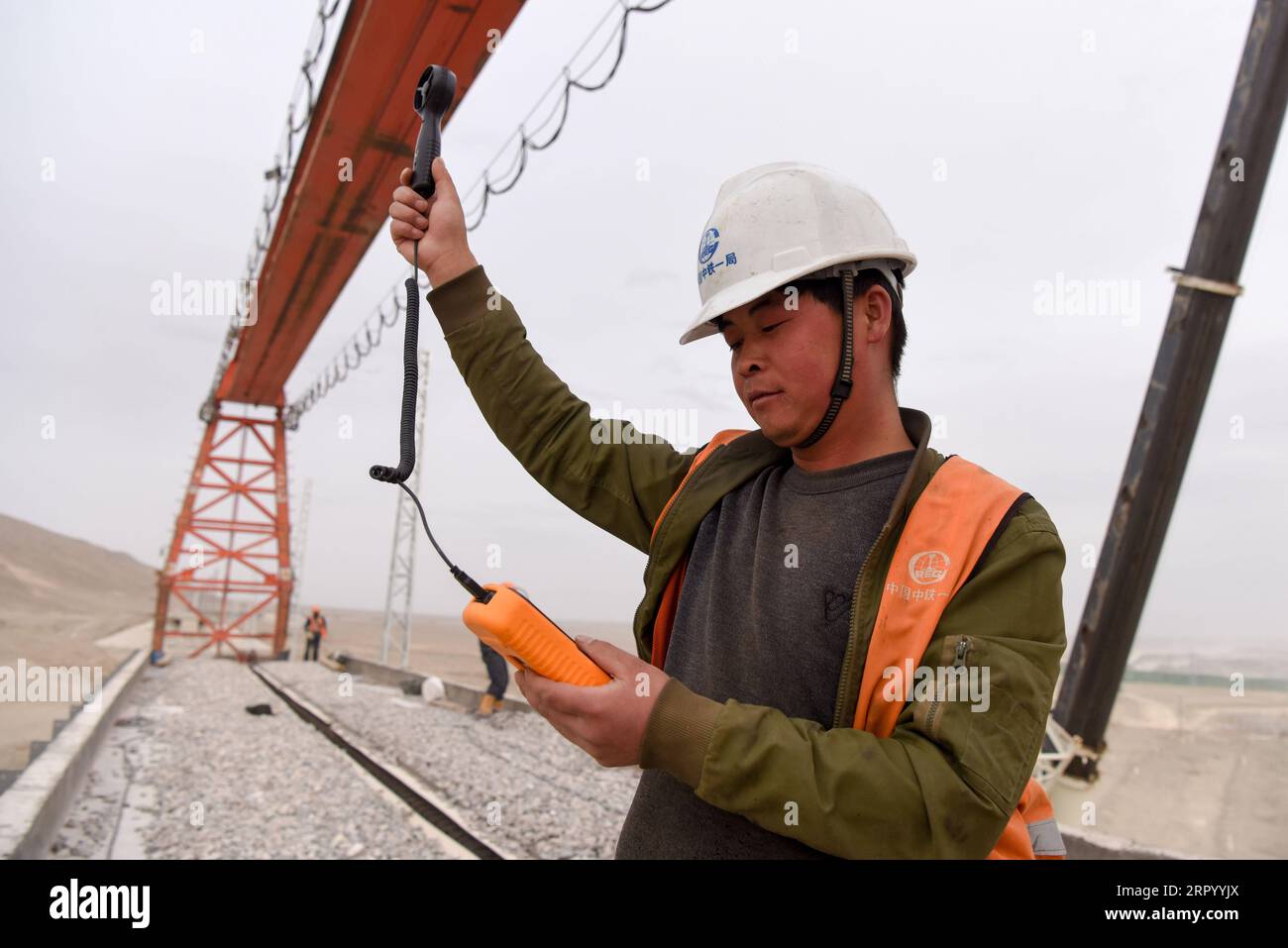 200719 -- RUOQIANG, July 19, 2020 -- A worker measures wind speed at ...
