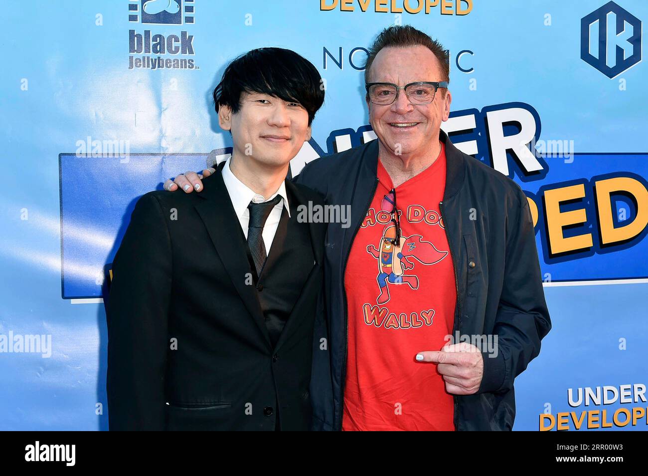 Brian Metcalf, left, and Tom Arnold attend the premiere of ...
