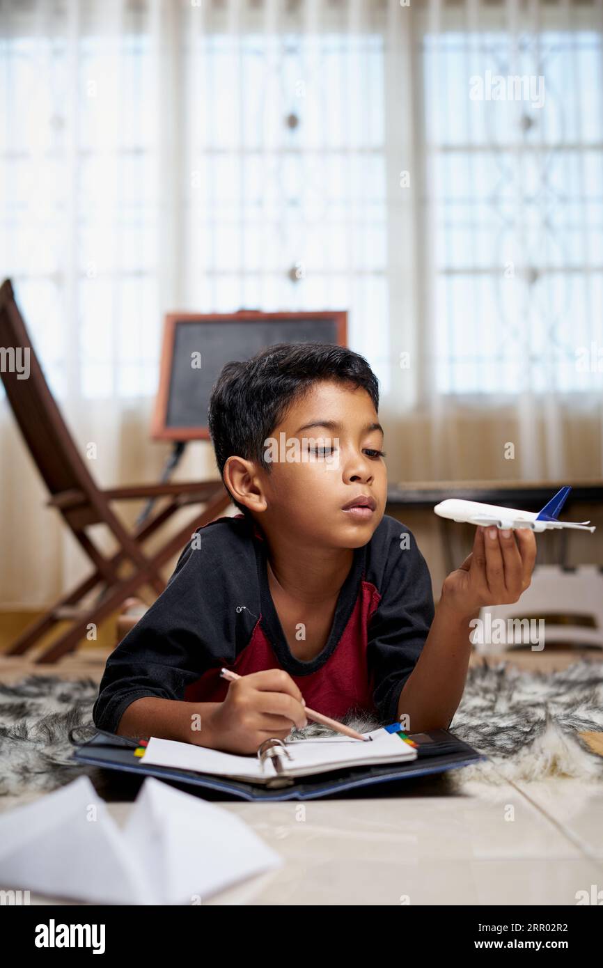 Asian cute boy doing homework hi-res stock photography and images - Alamy
