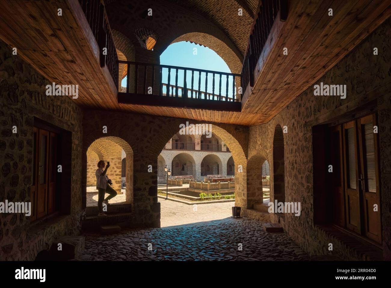 A tourist photographs the ancient architecture of the caravanserai in ...