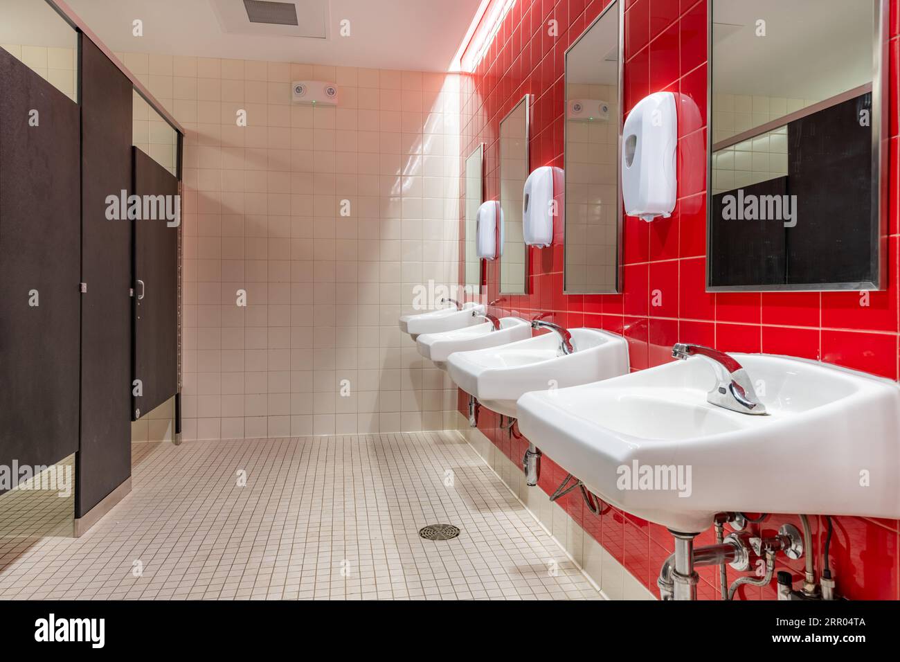 Public restroom with red tile and four, lavatories, sinks Stock Photo ...