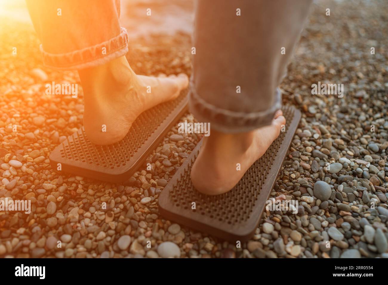 Sea Woman feet stepping on sadhu board during indian practice on the ...