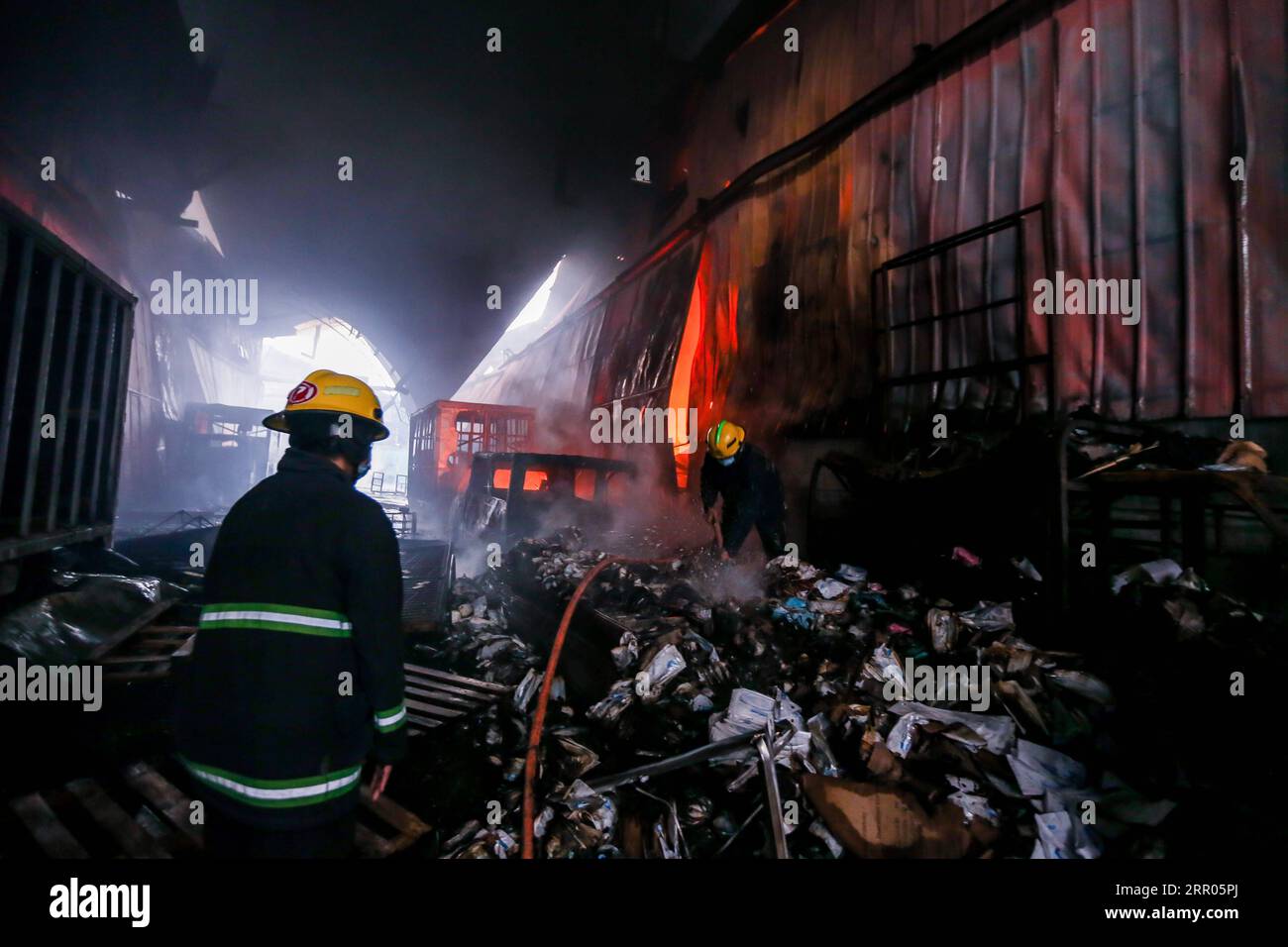 200730 -- MANILA, July 30, 2020 -- Firefighters work to put out the ...
