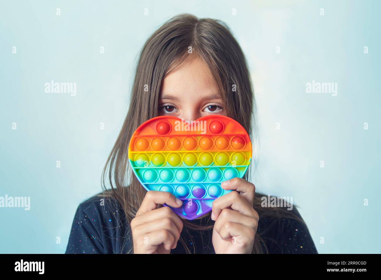 Cute faceless child playing with the Pop It fidget. Push pop bubble ...