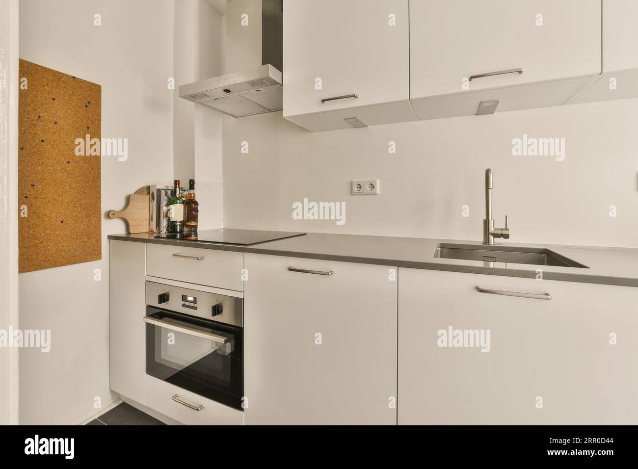 a kitchen with white cupboards and black counter tops on the wall ...
