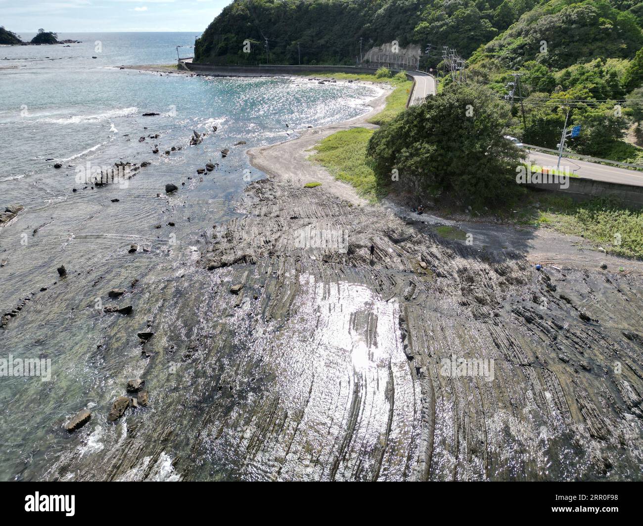 A tranquil, picturesque scene of a rocky ocean coastline in Japan is ...