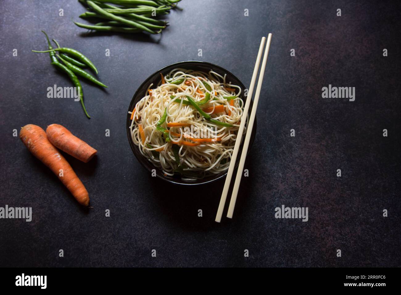 Wok tossed udon noodles served in a bowl. View from top Stock Photo - Alamy