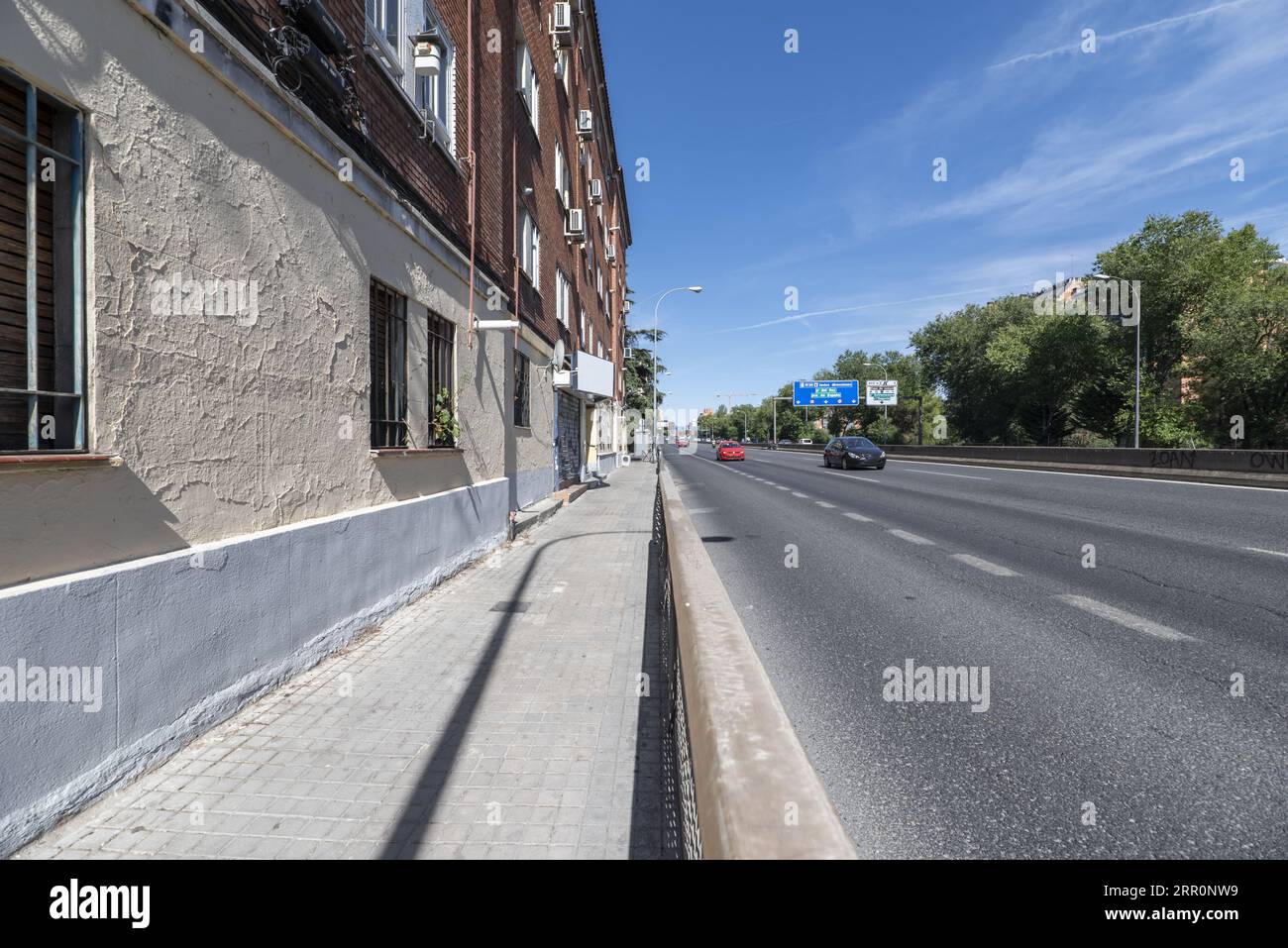 A road out of the city next to the low-rise residential buildings Stock ...