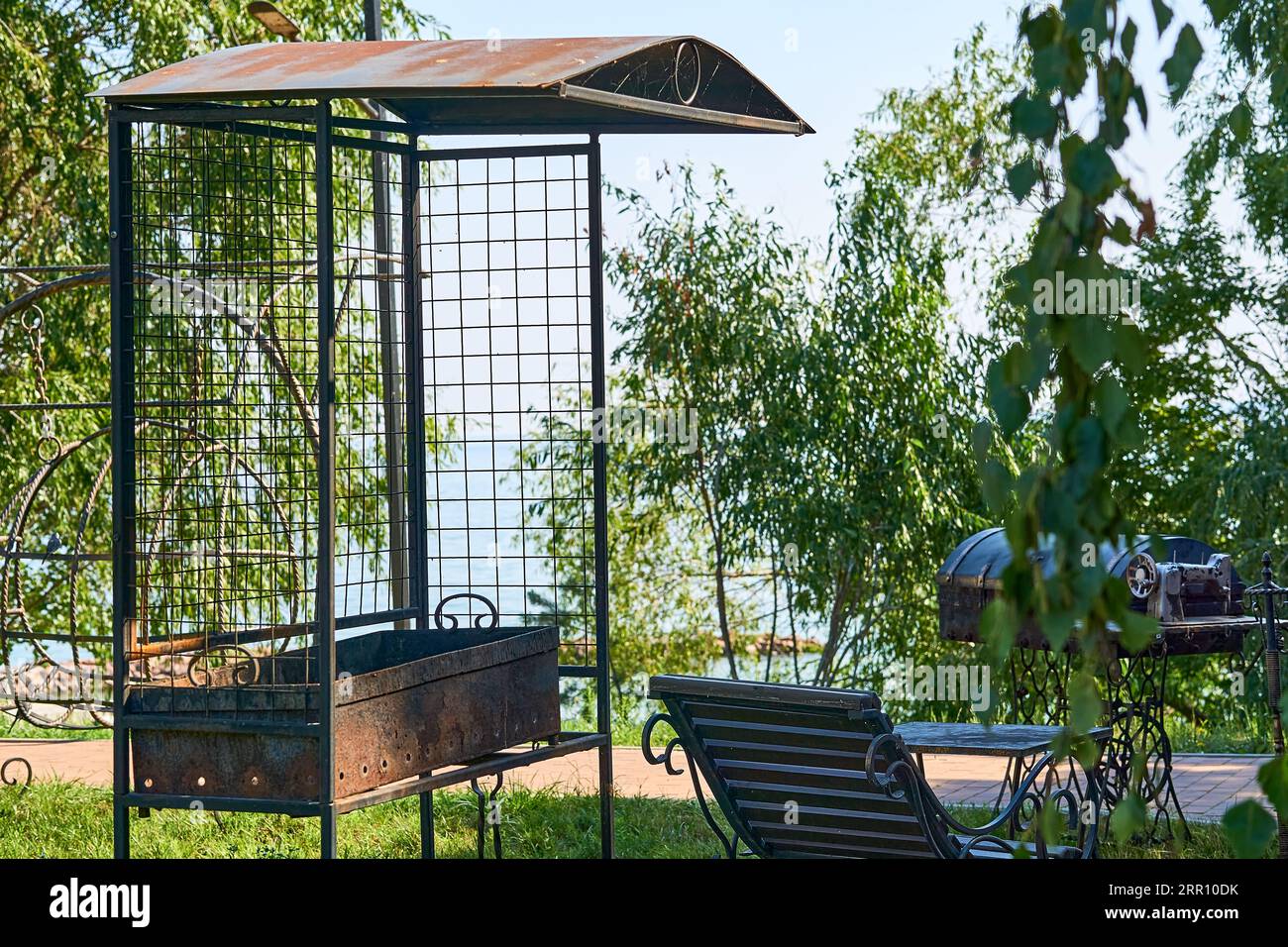 Iron brazier with a grate for hanging smoking products by the river in ...