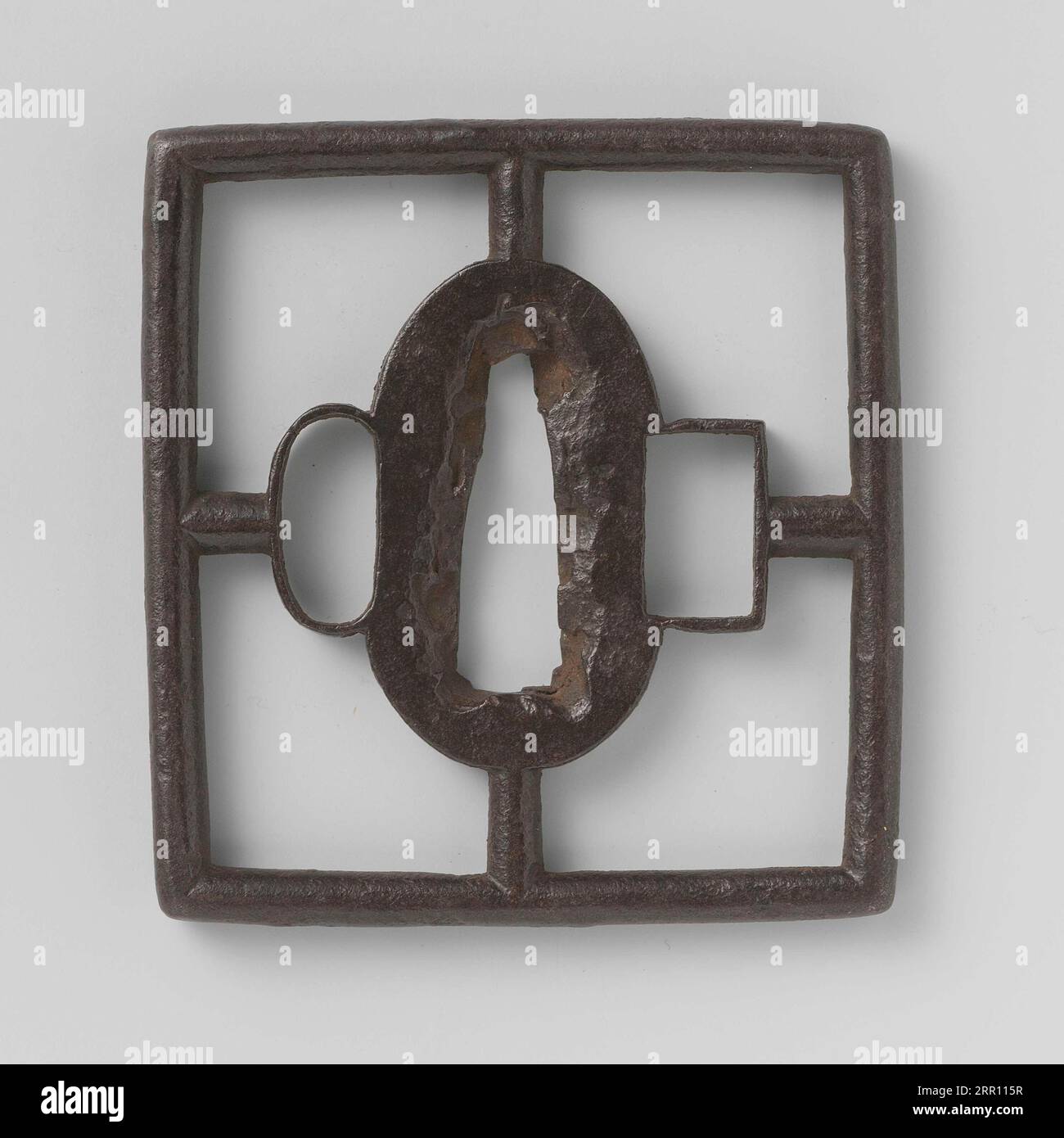 A round oval Iron Tsuba, a sword guard and part of a sword mounting. It ...