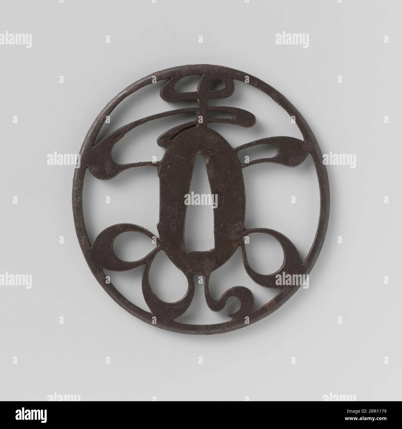 A round oval Iron Tsuba, a sword guard and part of a sword mounting. It ...