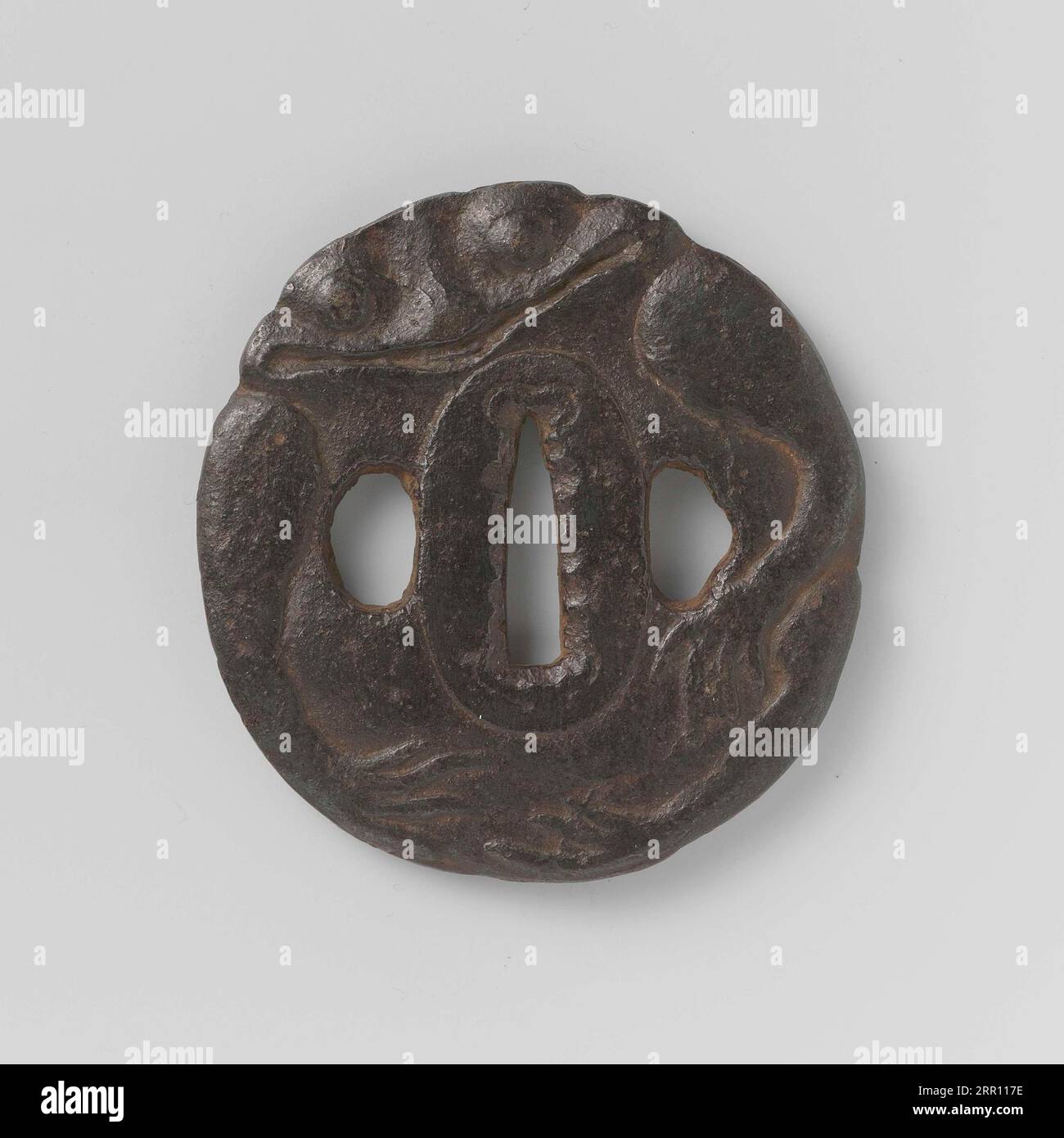 A round oval Iron Tsuba, a sword guard and part of a sword mounting. It ...