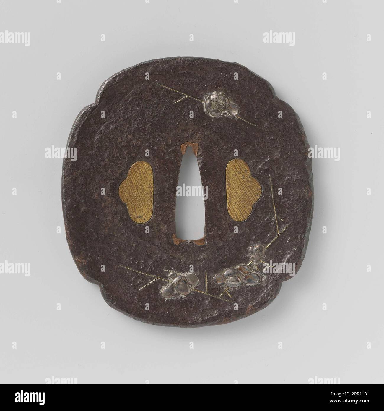 A round oval Iron Tsuba, a sword guard and part of a sword mounting. It ...