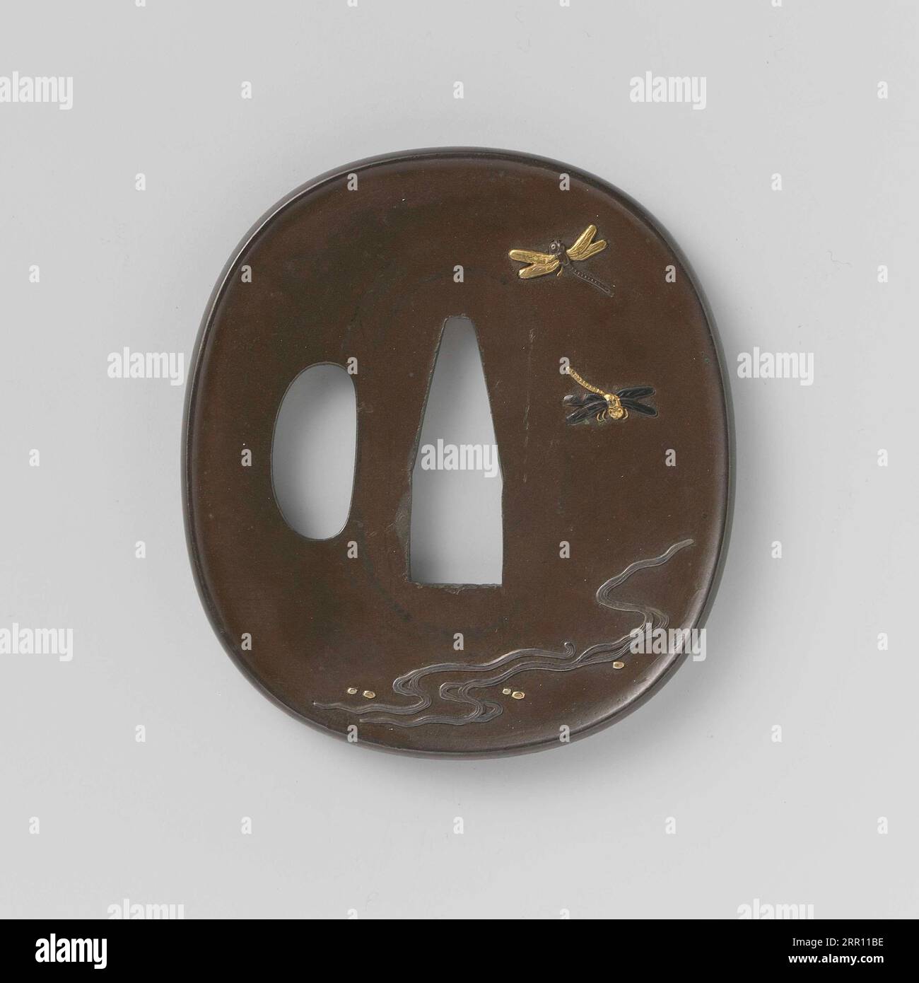 A round oval Iron Tsuba, a sword guard and part of a sword mounting. It ...