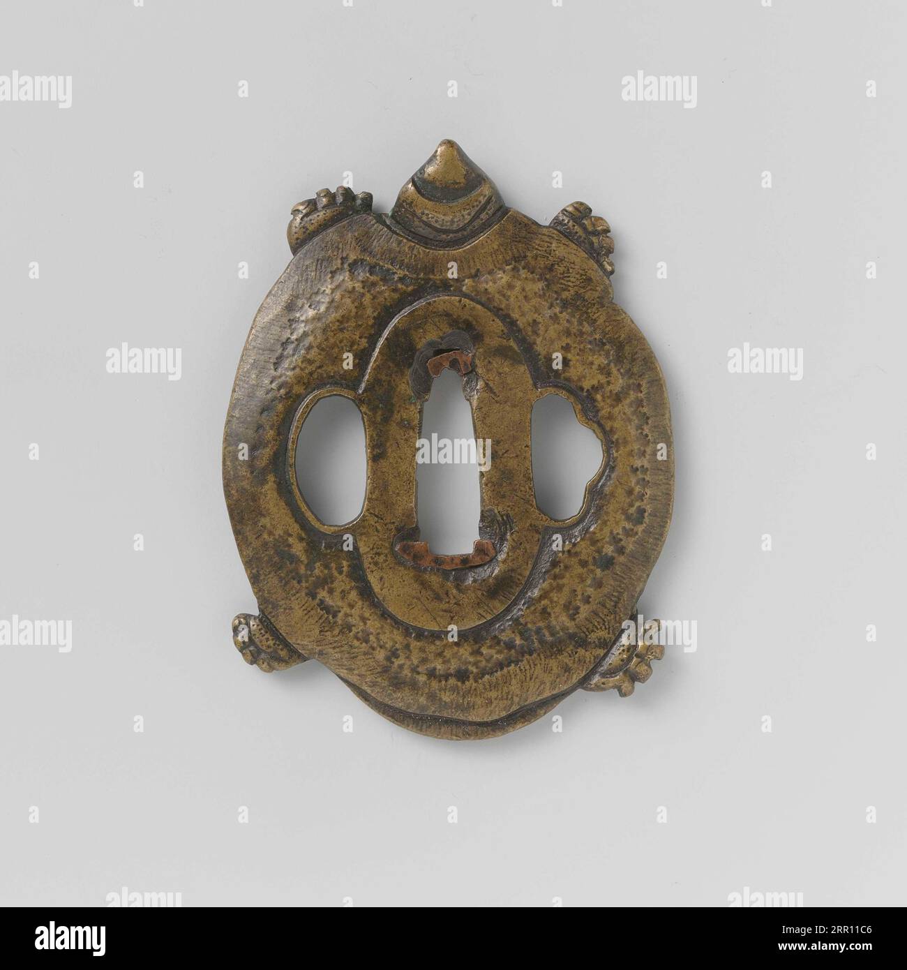 A round oval Iron Tsuba, a sword guard and part of a sword mounting. It ...